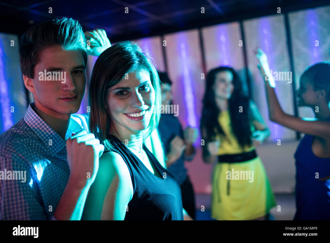 Smiling friends dancing on dance floor Stock Photo - Alamy