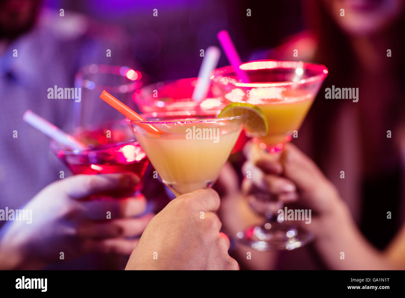 Group of friends toasting cocktail at bar counter Stock Photo - Alamy