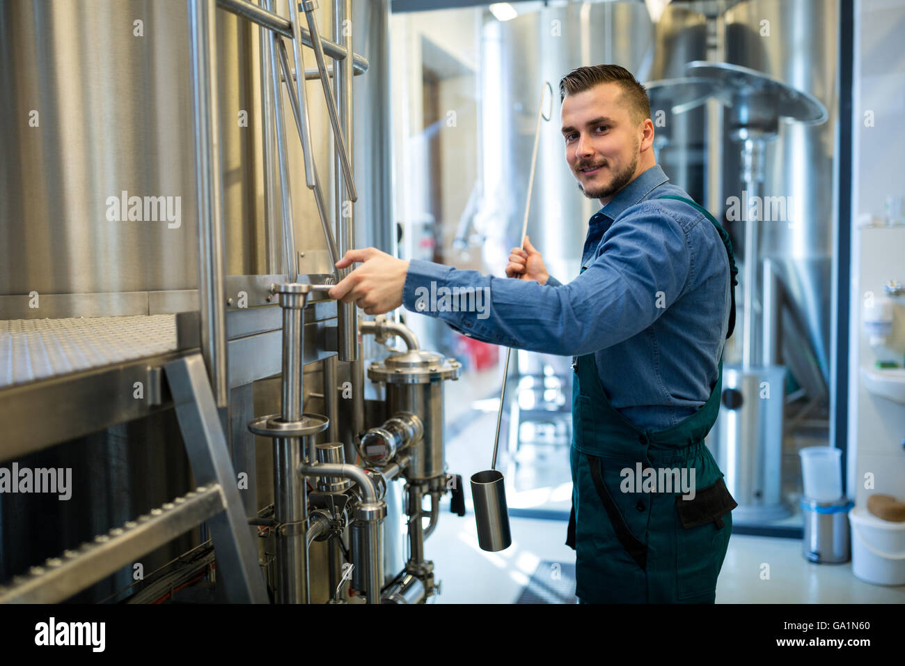 Brewer working at brewery Stock Photo - Alamy
