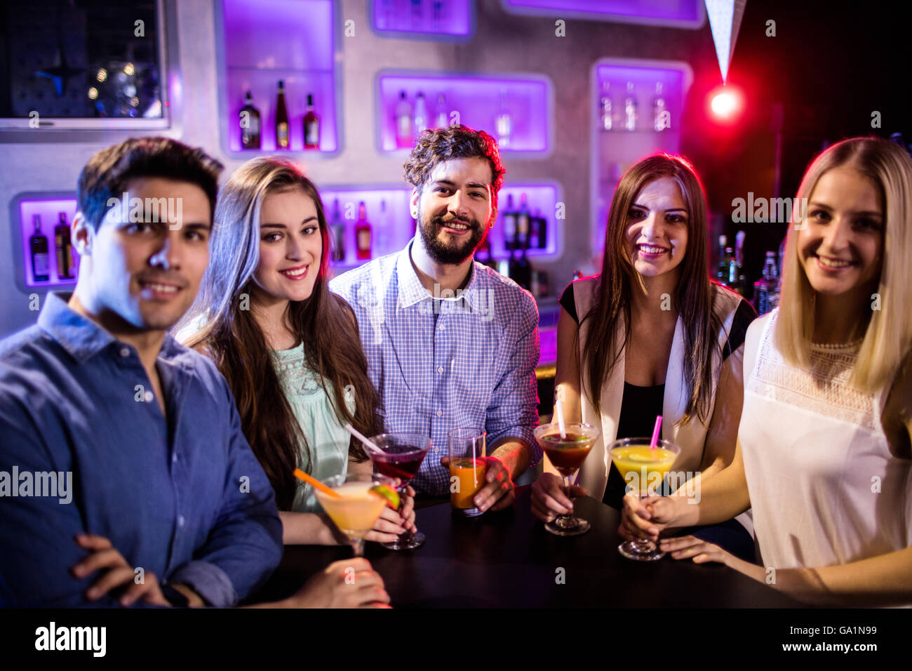 Group of friends having cocktail at bar counter Stock Photo - Alamy