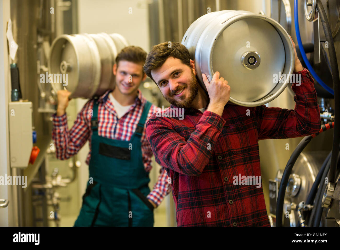 Brewers carrying keg on shoulder Stock Photo - Alamy