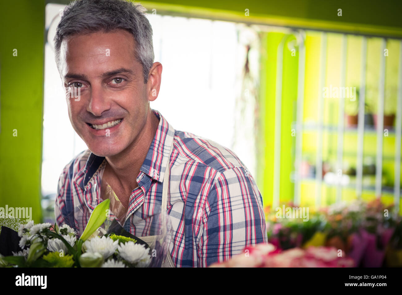 Smiling male florist at flower shop Stock Photo - Alamy