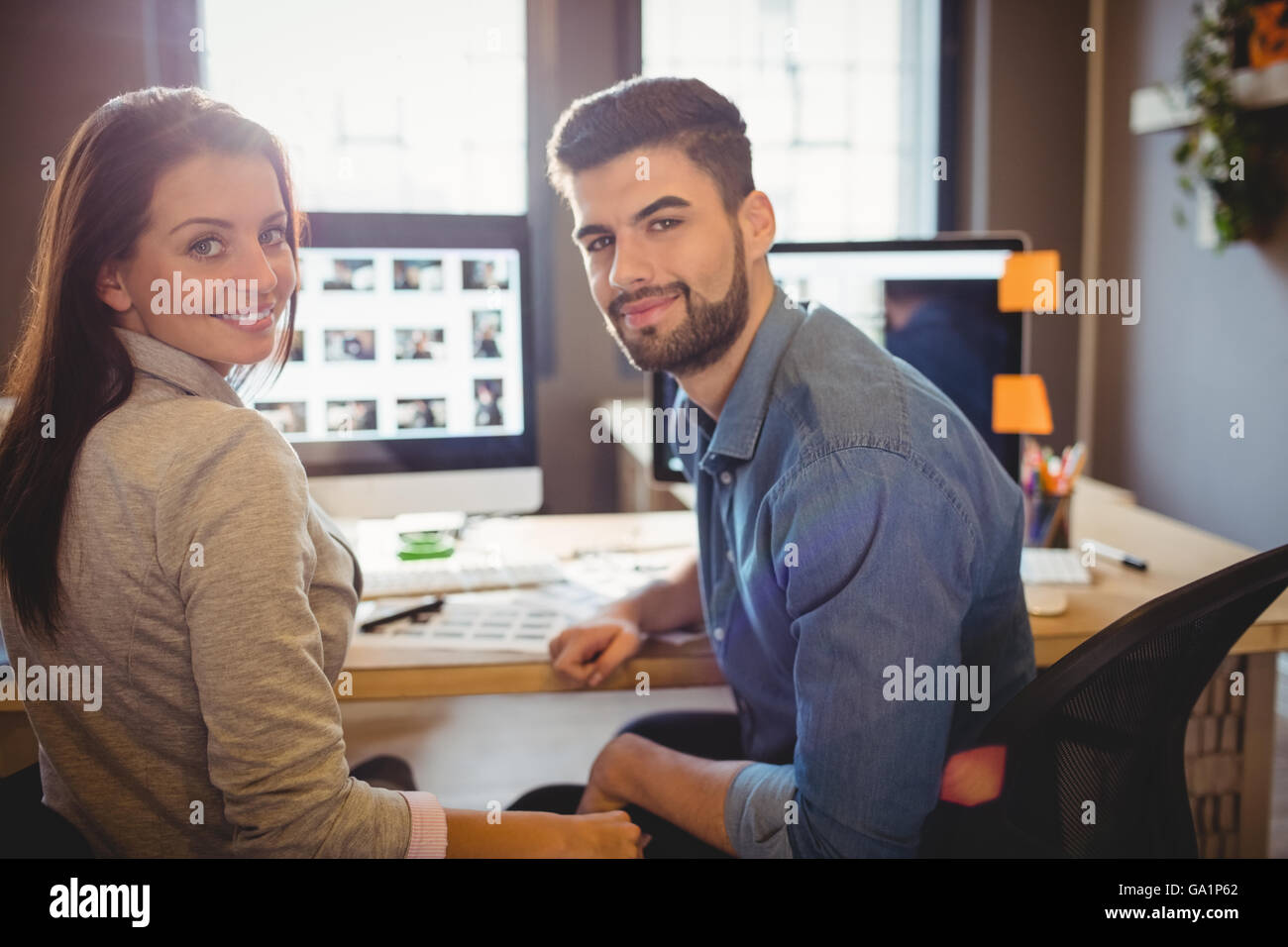 Graphic designers working at desk in the office Stock Photo - Alamy