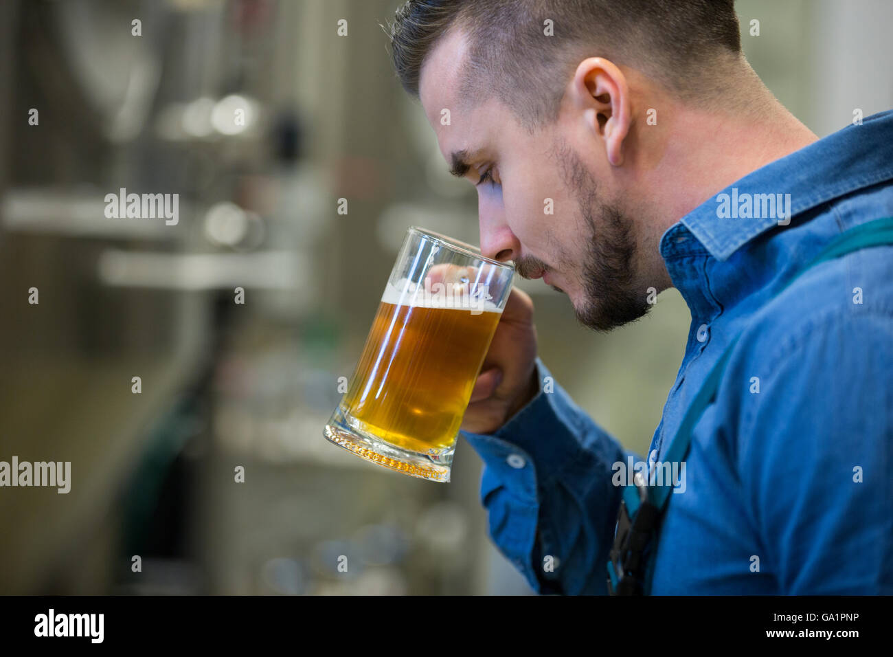 Close-up of brewer testing beer Stock Photo - Alamy