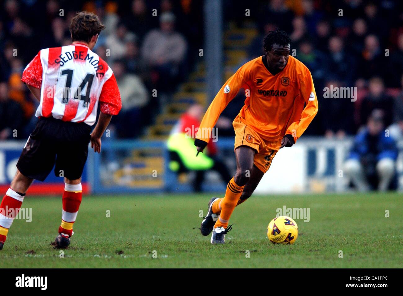 Hull City's Theo Whitmore (r) is watched by Lincoln City's Ben ...