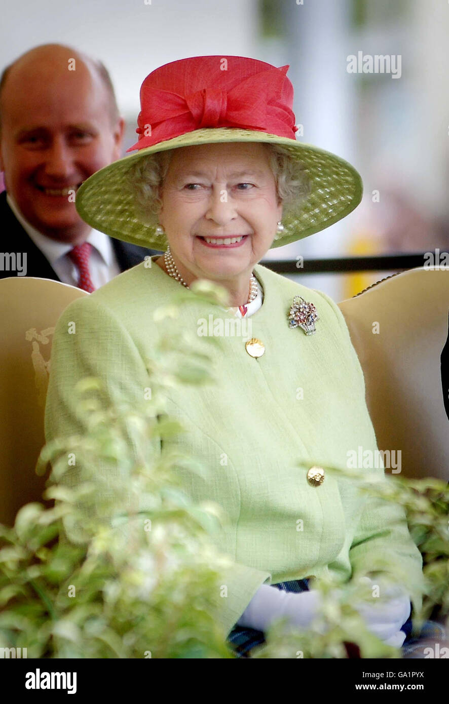 Queen Elizabeth II watches the procession at the third session of the ...