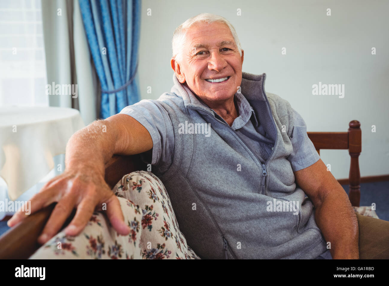 Senior man sitting on a couch Stock Photo - Alamy