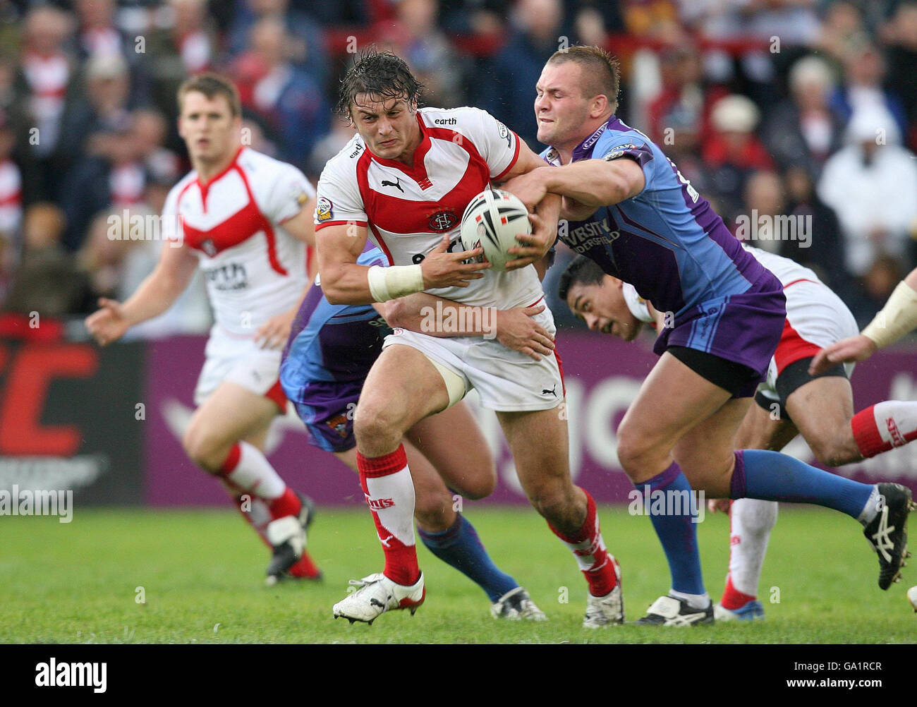 St Helens' Jon Wilkin is tackled by Huddersfield's Darrell Griffin ...