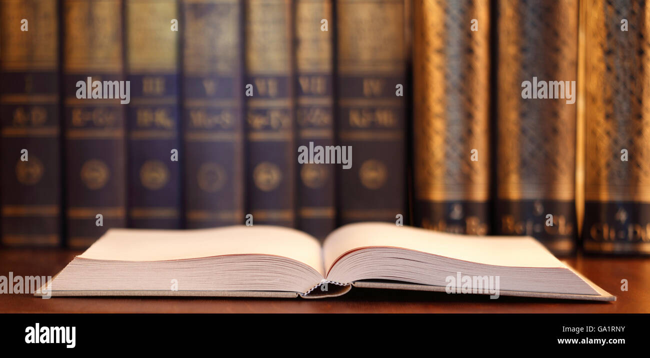 Opened and closed vintage books in a library Stock Photo - Alamy