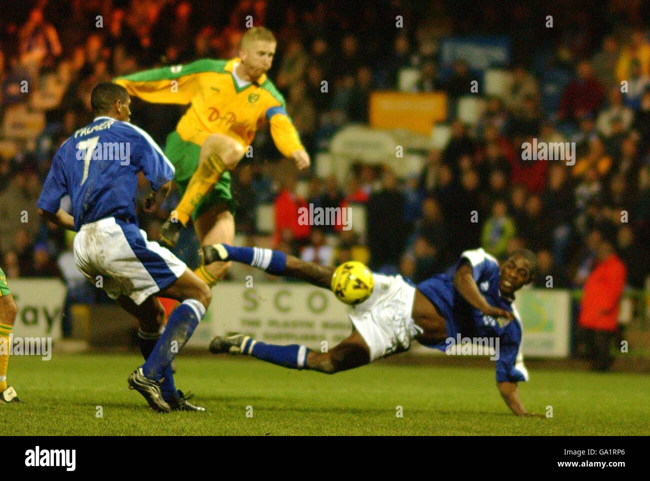 Stockport County's Carlton Palmer and Leo Roget combine to stop Norwich ...