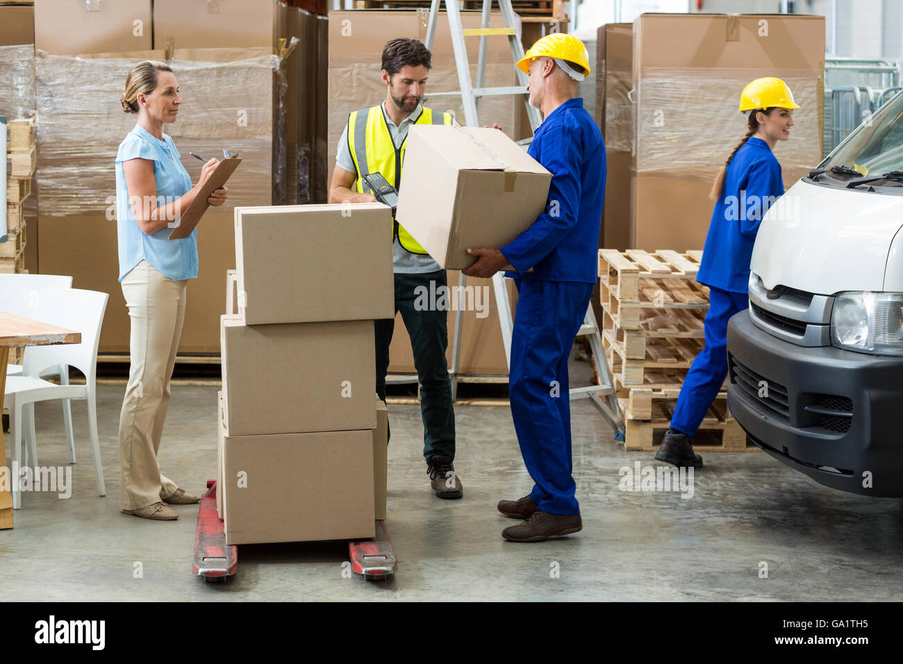 Workers carrying boxes Stock Photo - Alamy