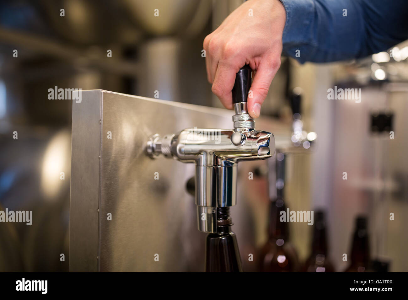 Brewer filling beer in bottle Stock Photo - Alamy