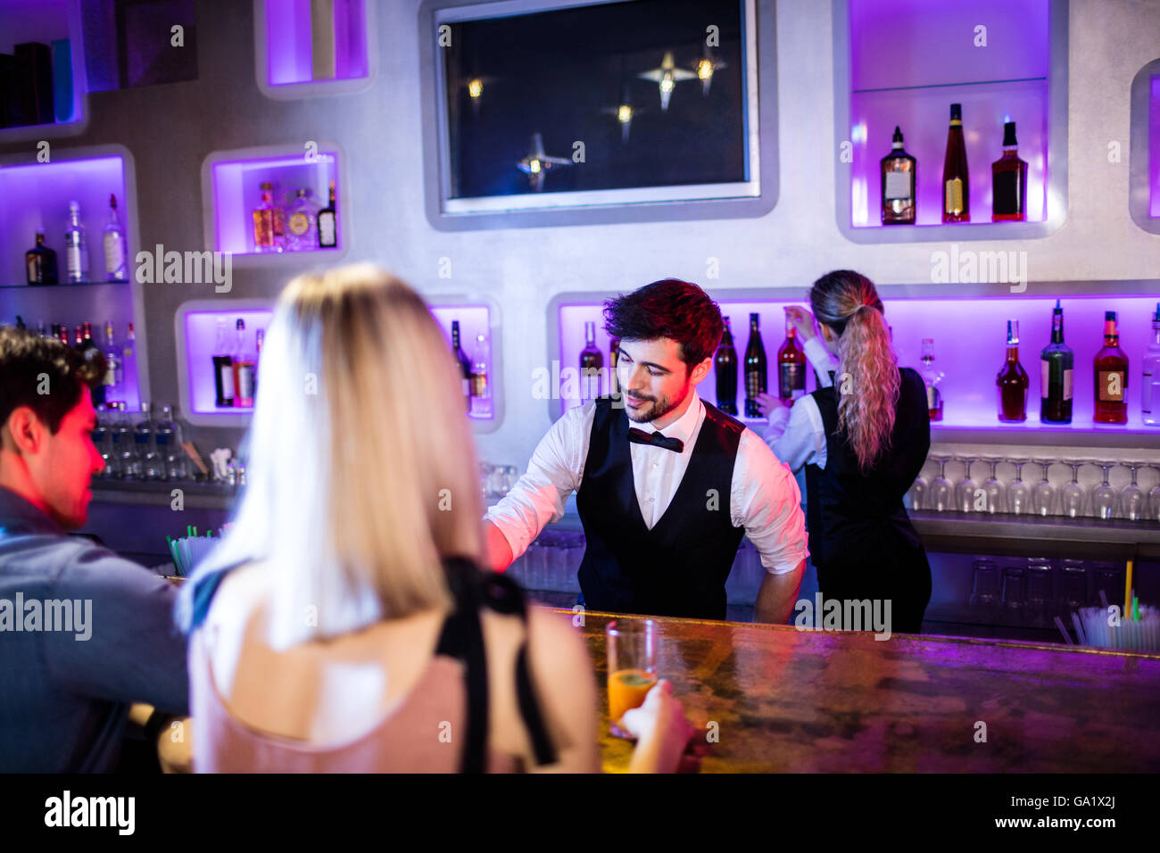 Waiter serving cocktail Stock Photo - Alamy