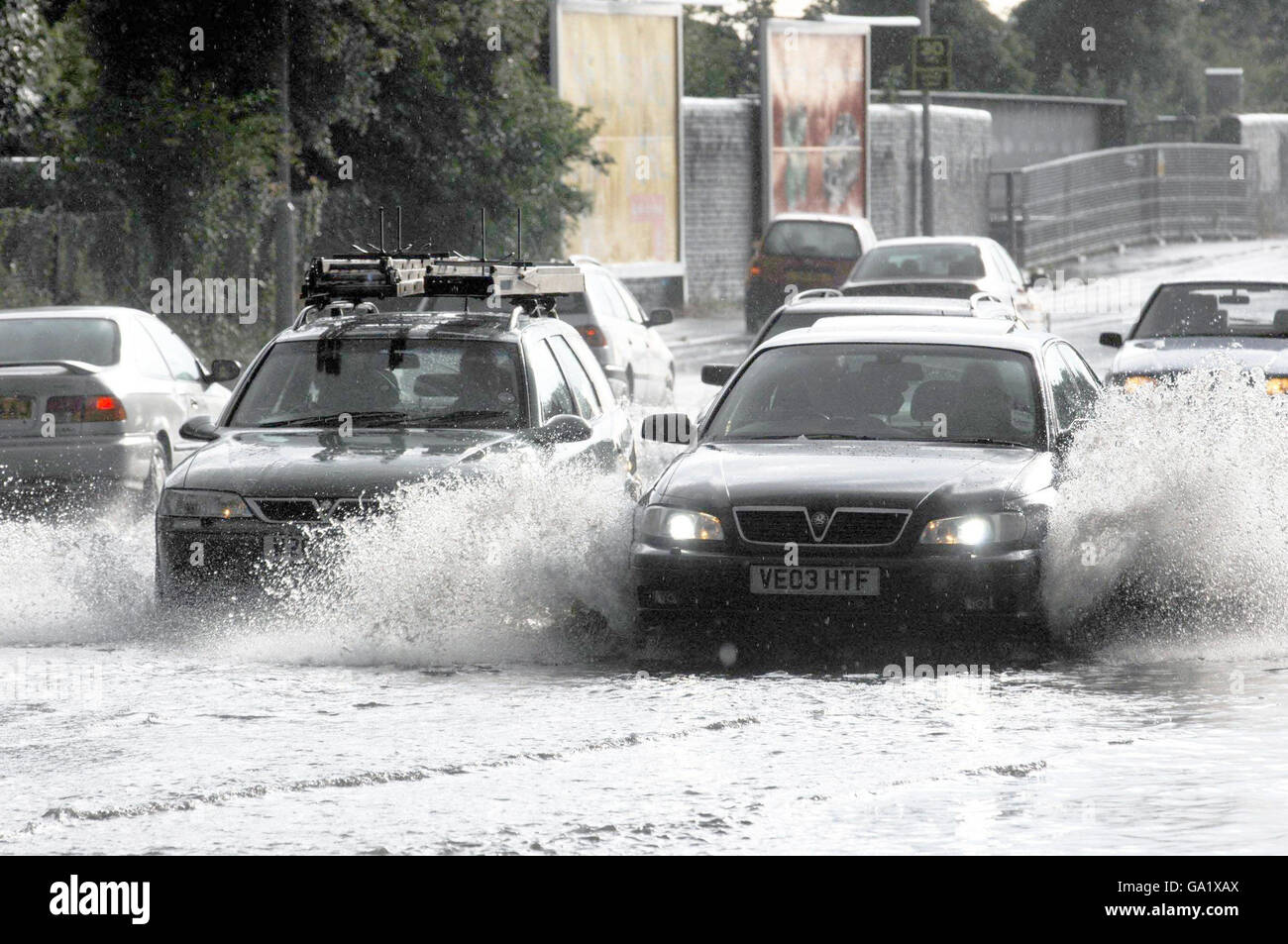 Flooding hits Britain. Drivers struggle along flooded Forest Road in ...
