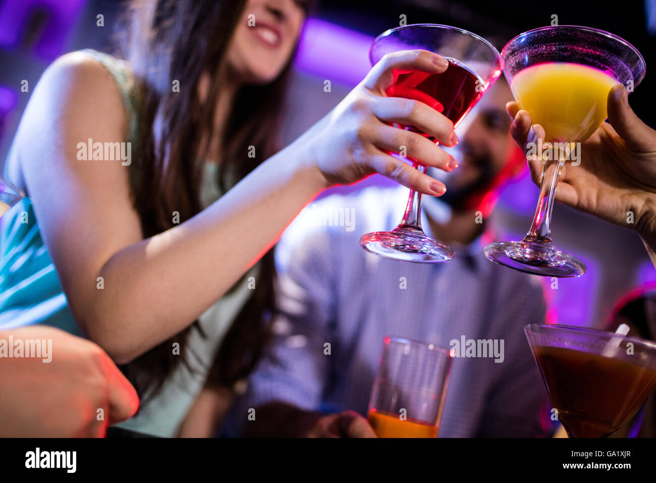 Friends toasting cocktail at bar counter Stock Photo - Alamy