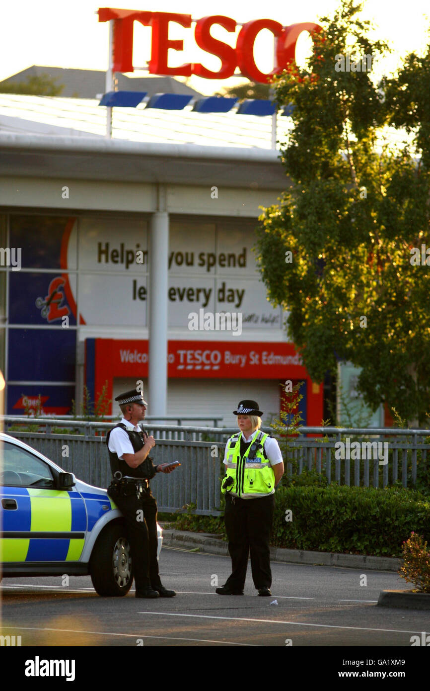 Police officers outside a closed Tesco superstore at Bury St Edmunds ...