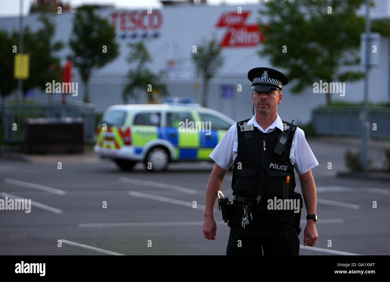 Police officers outside a closed Tesco superstore at Bury St Edmunds ...