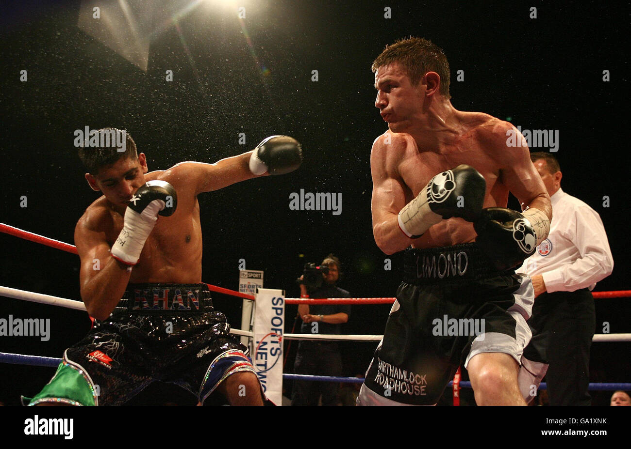 England's Amir Khan (left) and Scotland's Willie Limond in action ...