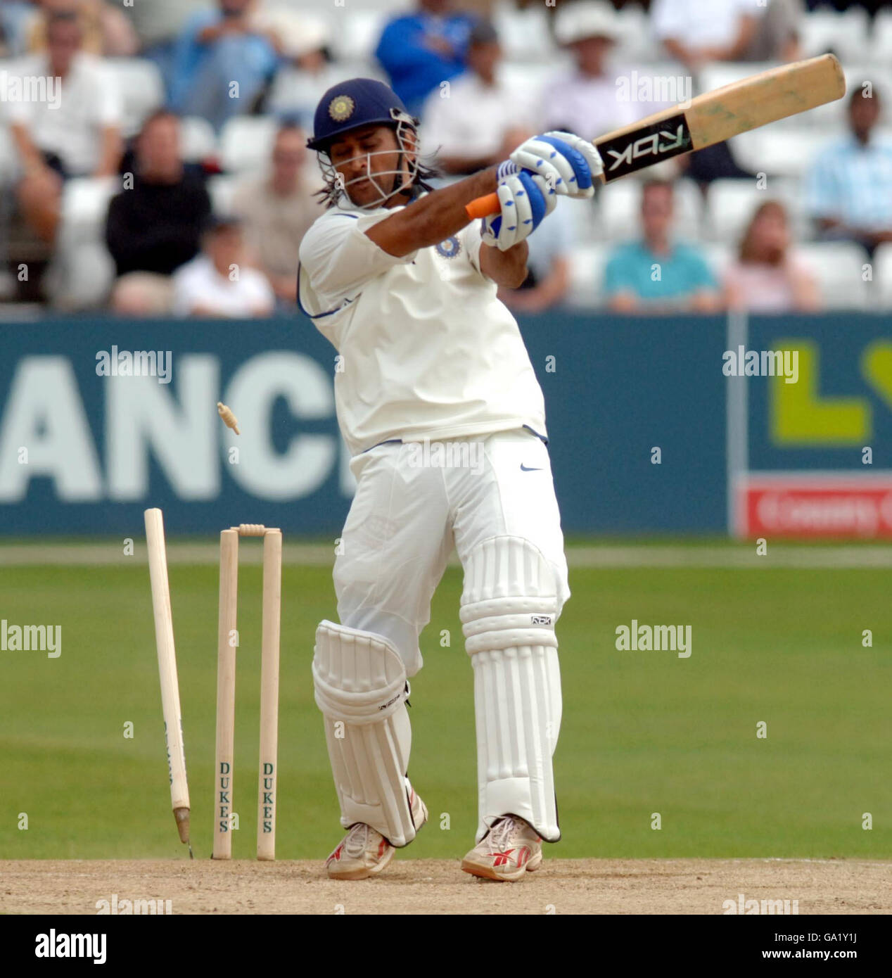 India's Mahendra Dhoni is clean bowled by England Lions' Stuart Broad ...