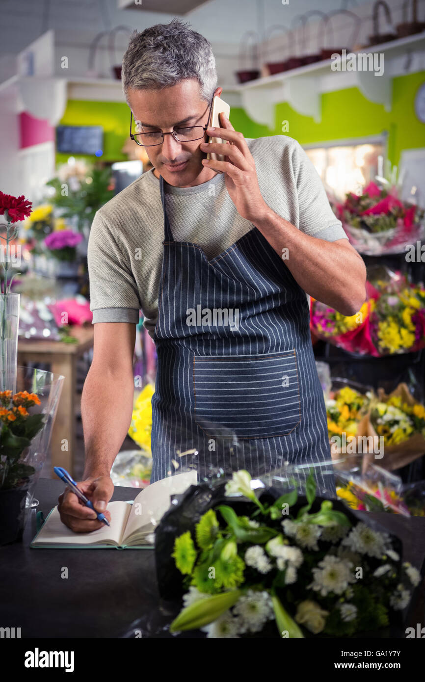 Mid adult man taking order of flowers hi-res stock photography and ...