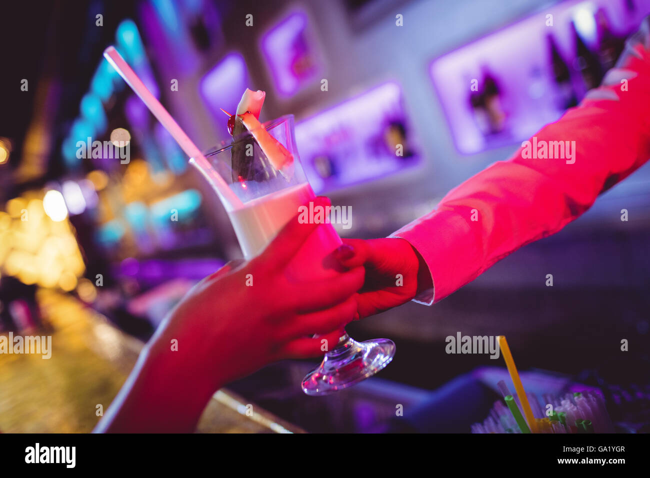 Hand of waitress serving cocktail Stock Photo - Alamy