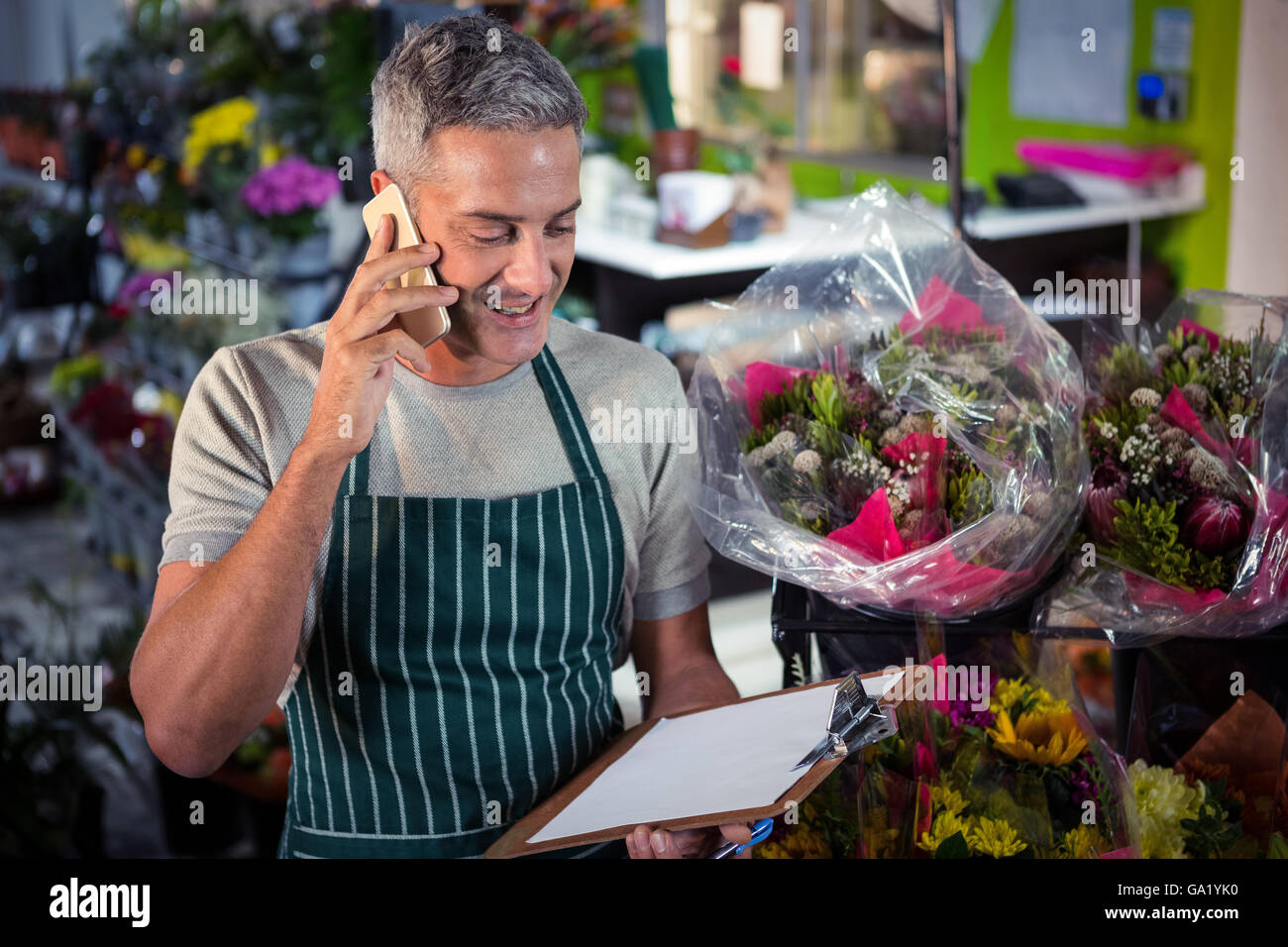 Mid adult man taking order of flowers hi-res stock photography and ...