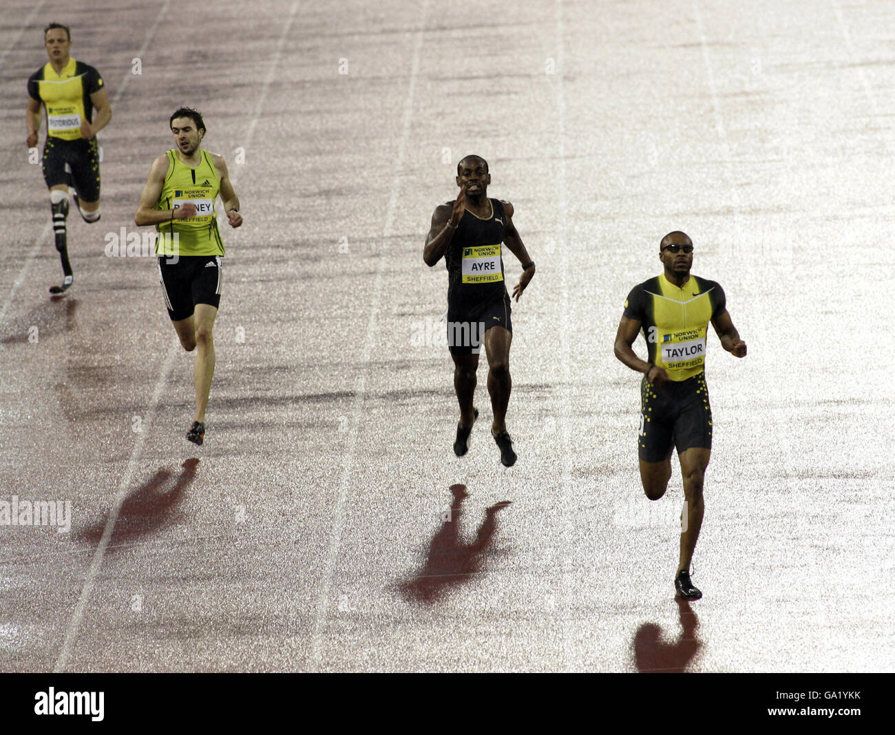 South Africa's Oscar Pistorius (left) the blade runner trails in behind ...