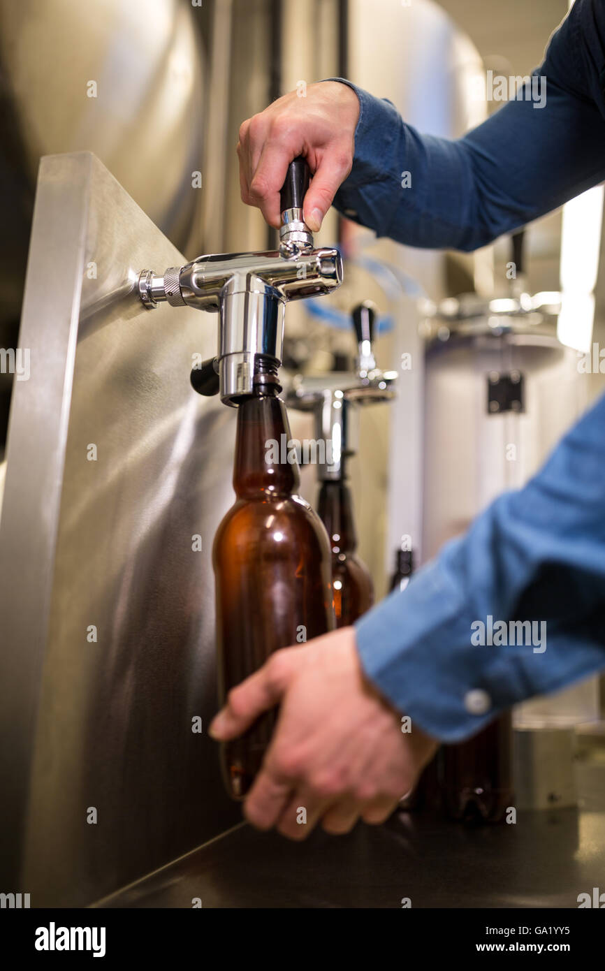 Brewer filling beer in bottle Stock Photo - Alamy