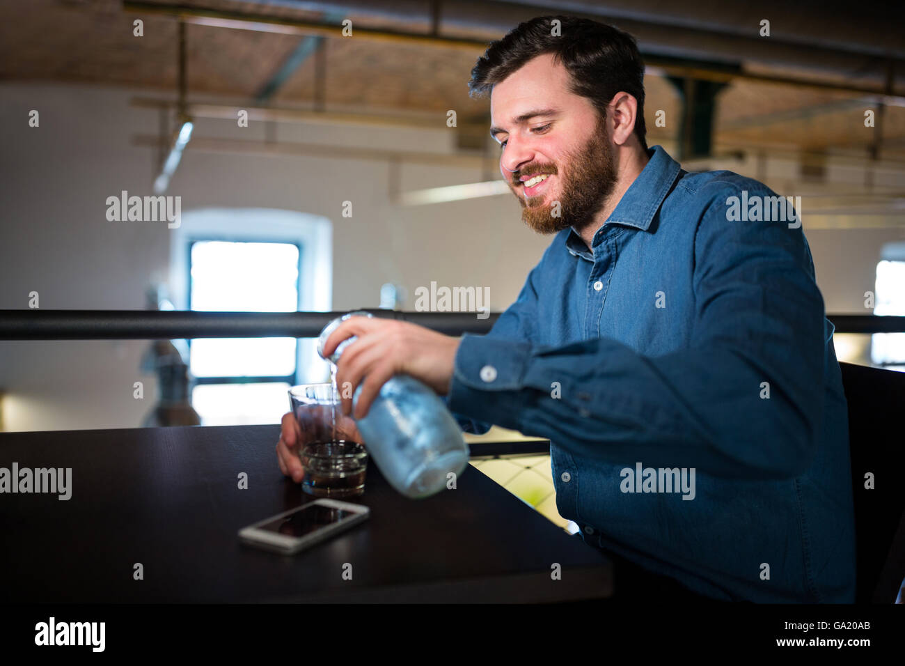 Man pouring water glass hi-res stock photography and images - Alamy