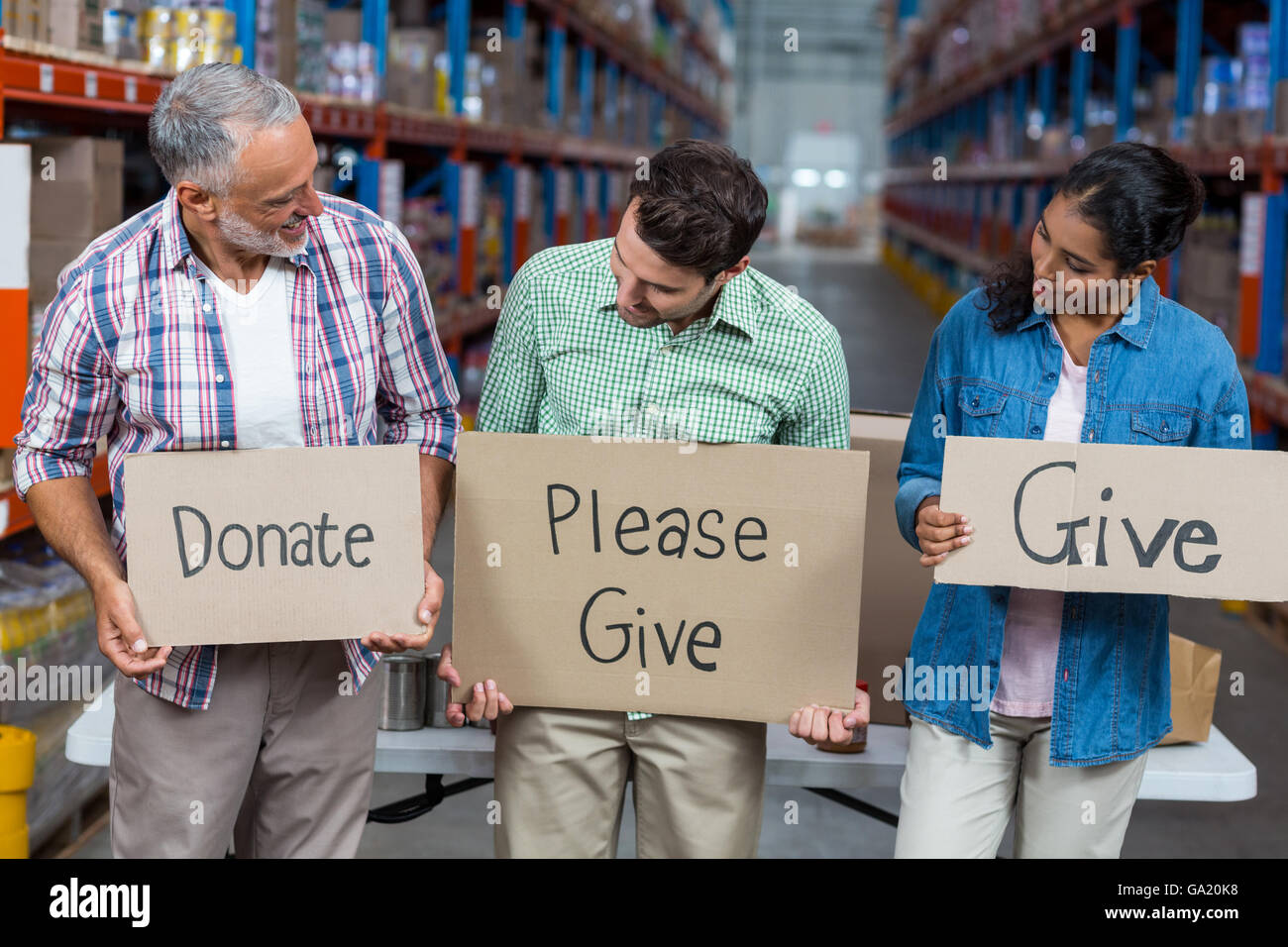Happy volunteer holding sign and looking the messages Stock Photo - Alamy