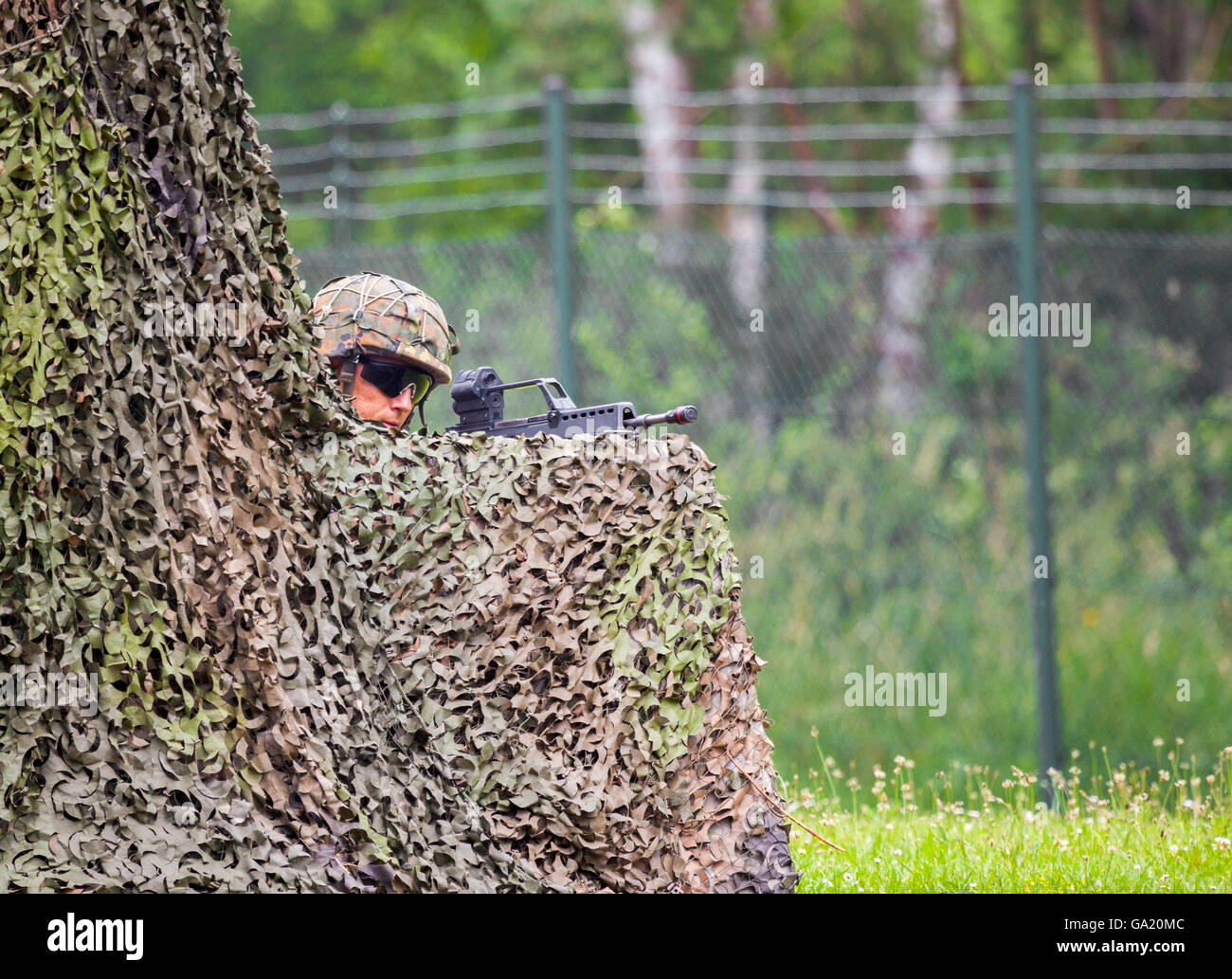 BURG / GERMANY - JUNE 25, 2016: german soldier fires with hk g 36 rifle ...