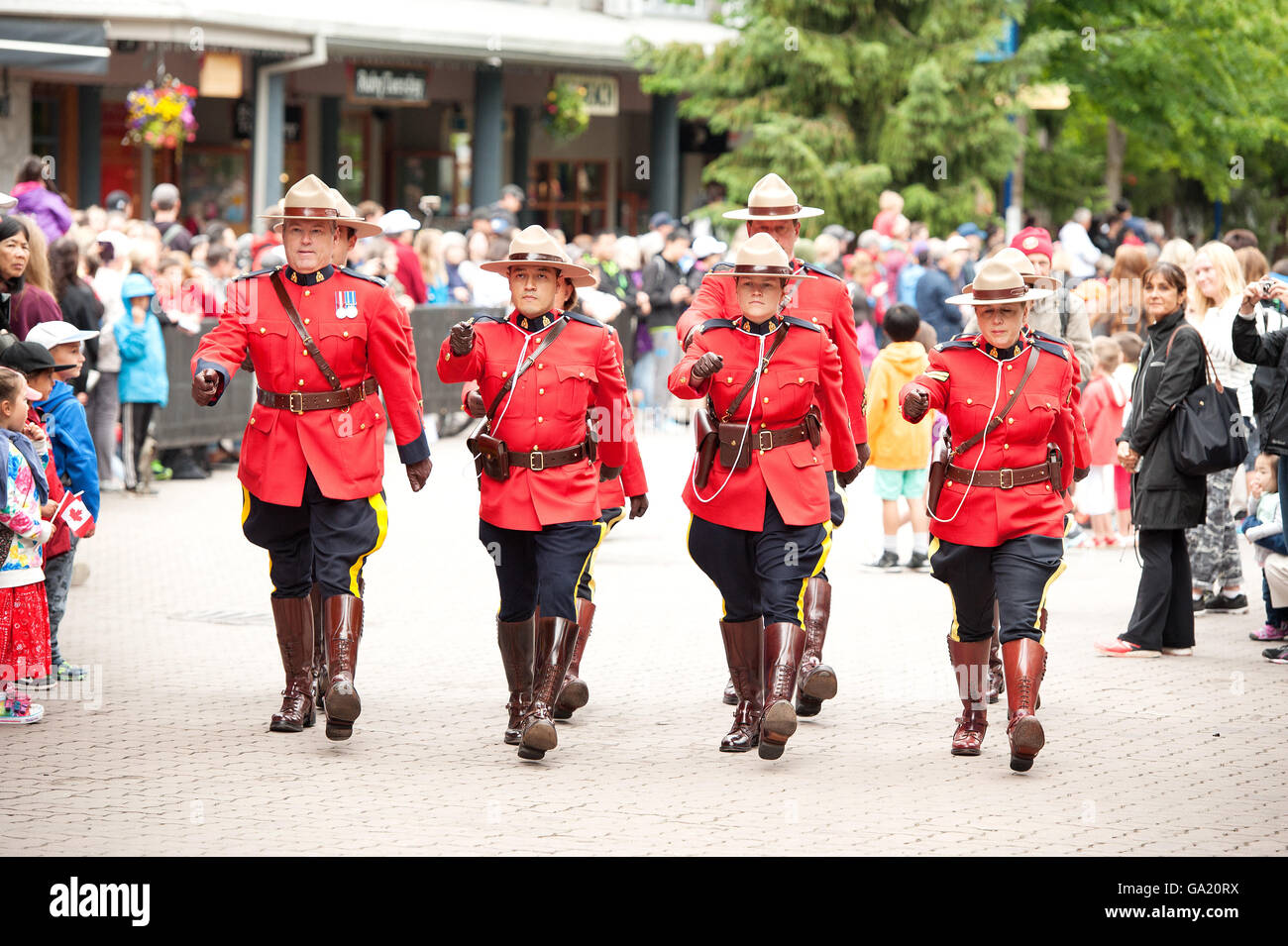 A Troop of RCMP Police officers in traditional red serge march in the ...