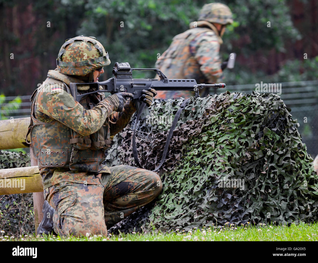 BURG / GERMANY - JUNE 25, 2016: german soldier fires with hk g 36 rifle ...