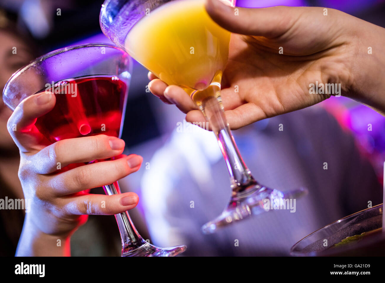 Friends toasting cocktail at bar counter Stock Photo - Alamy