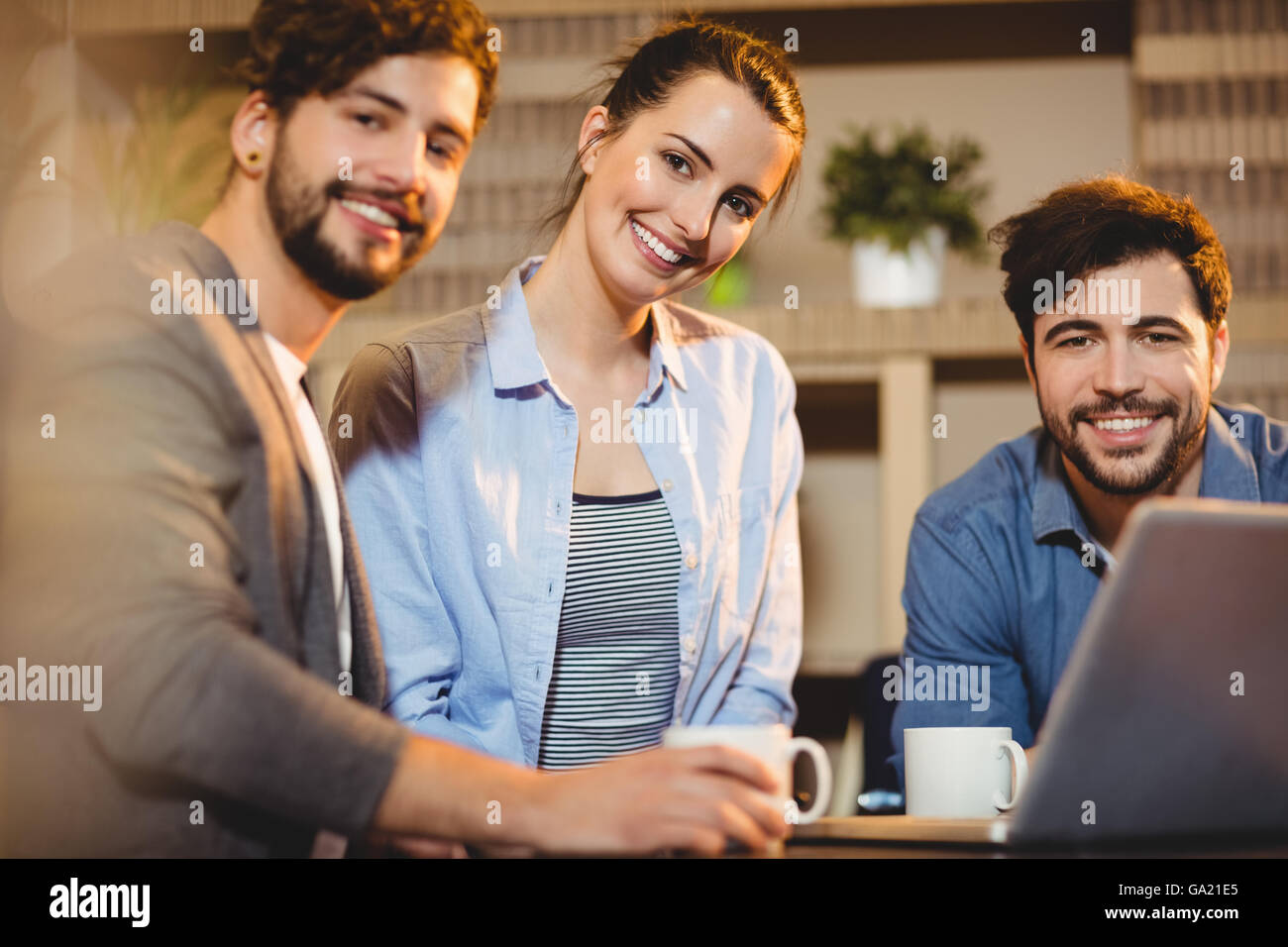 Colleagues using laptop Stock Photo - Alamy
