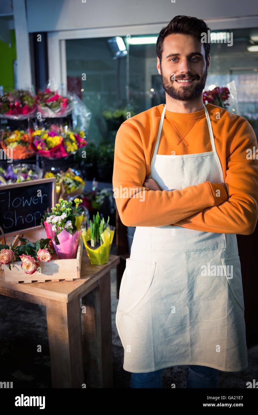 Male florist standing with arms crossed Stock Photo - Alamy