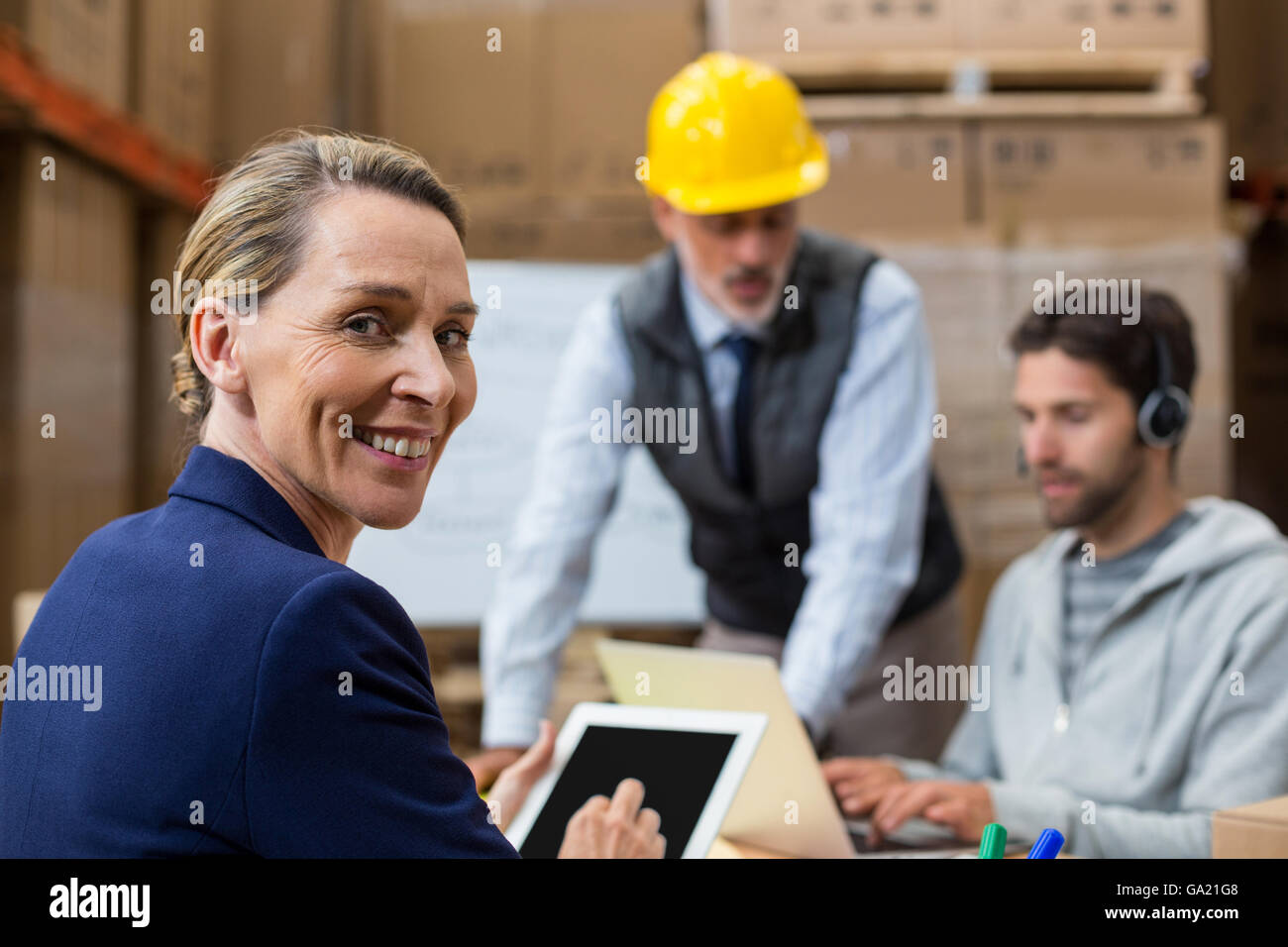 Smiling workers looking at camera Stock Photo - Alamy