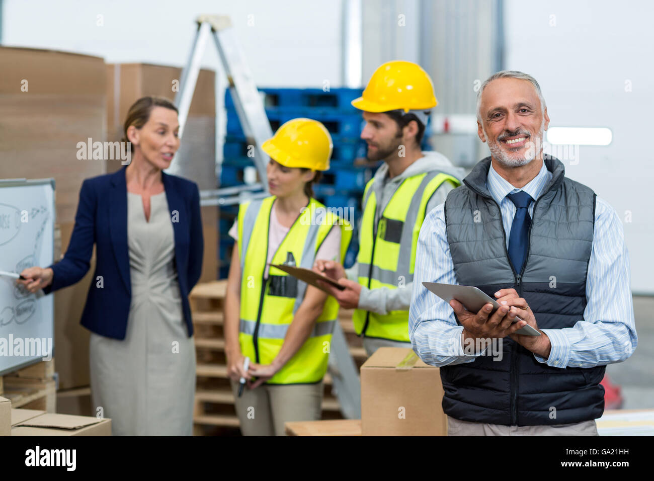 Warehouse team having a meeting Stock Photo - Alamy