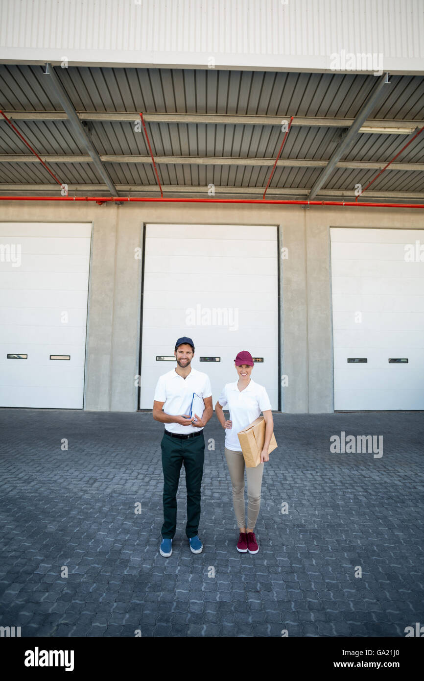 Delivery people are posing and holding goods Stock Photo - Alamy