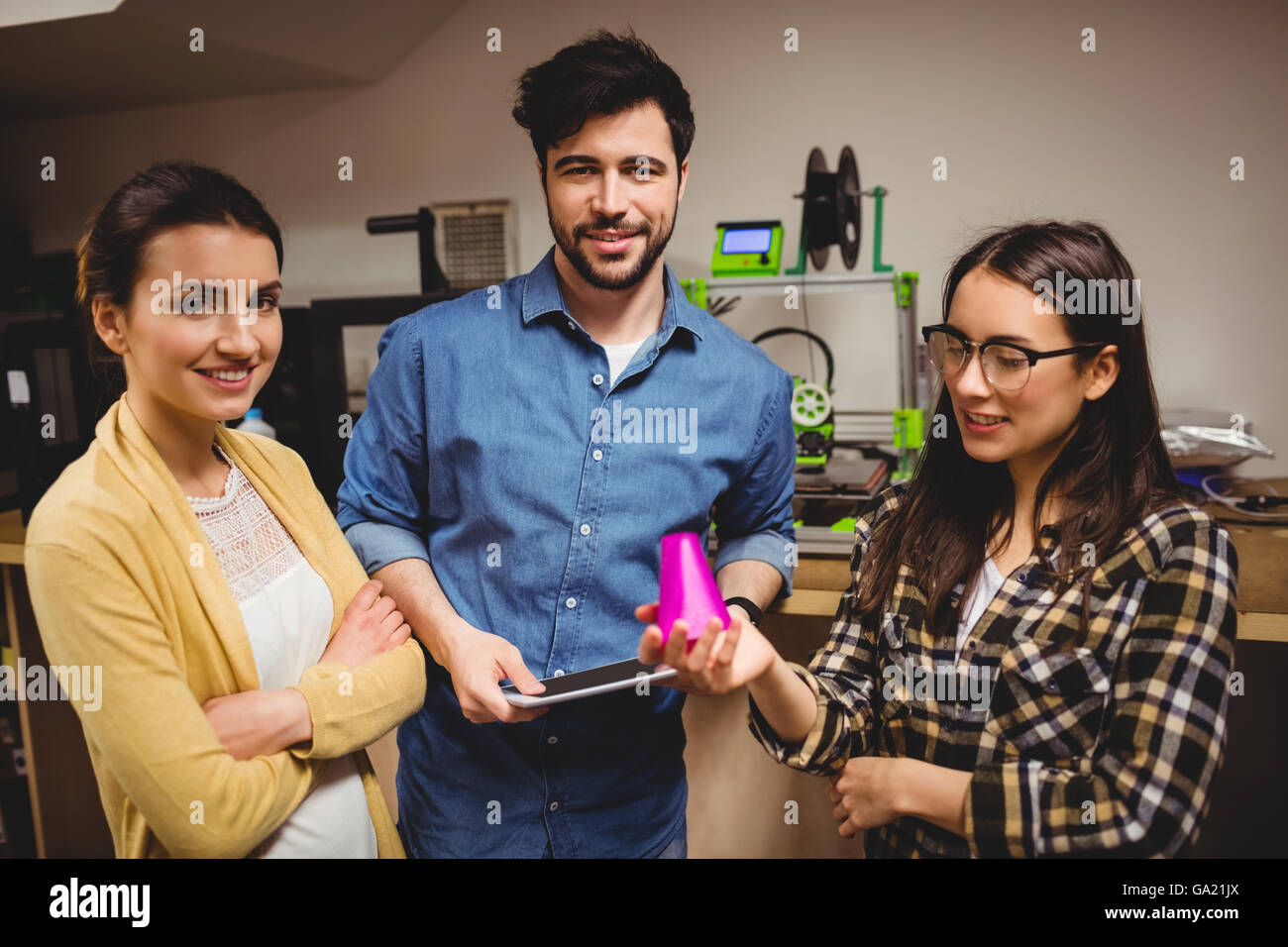 Graphic designers standing in office Stock Photo - Alamy