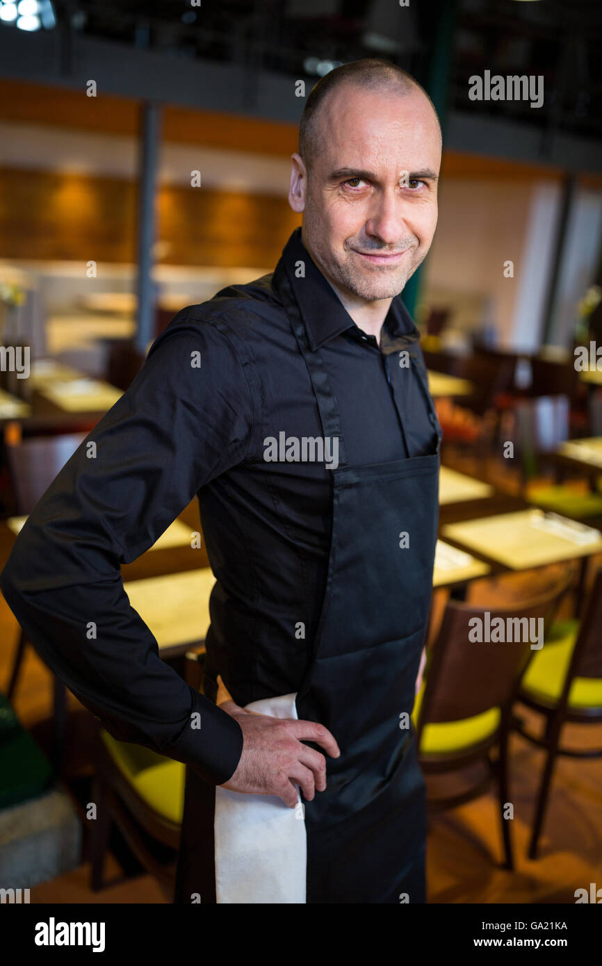 Happy waiter standing in resturant Stock Photo - Alamy