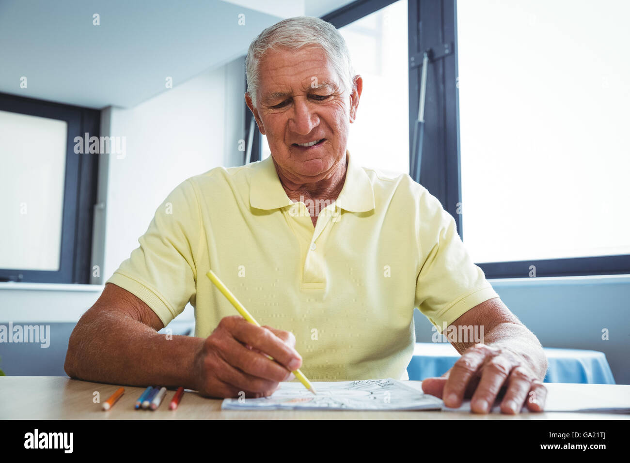 Senior man using a colouring book Stock Photo - Alamy