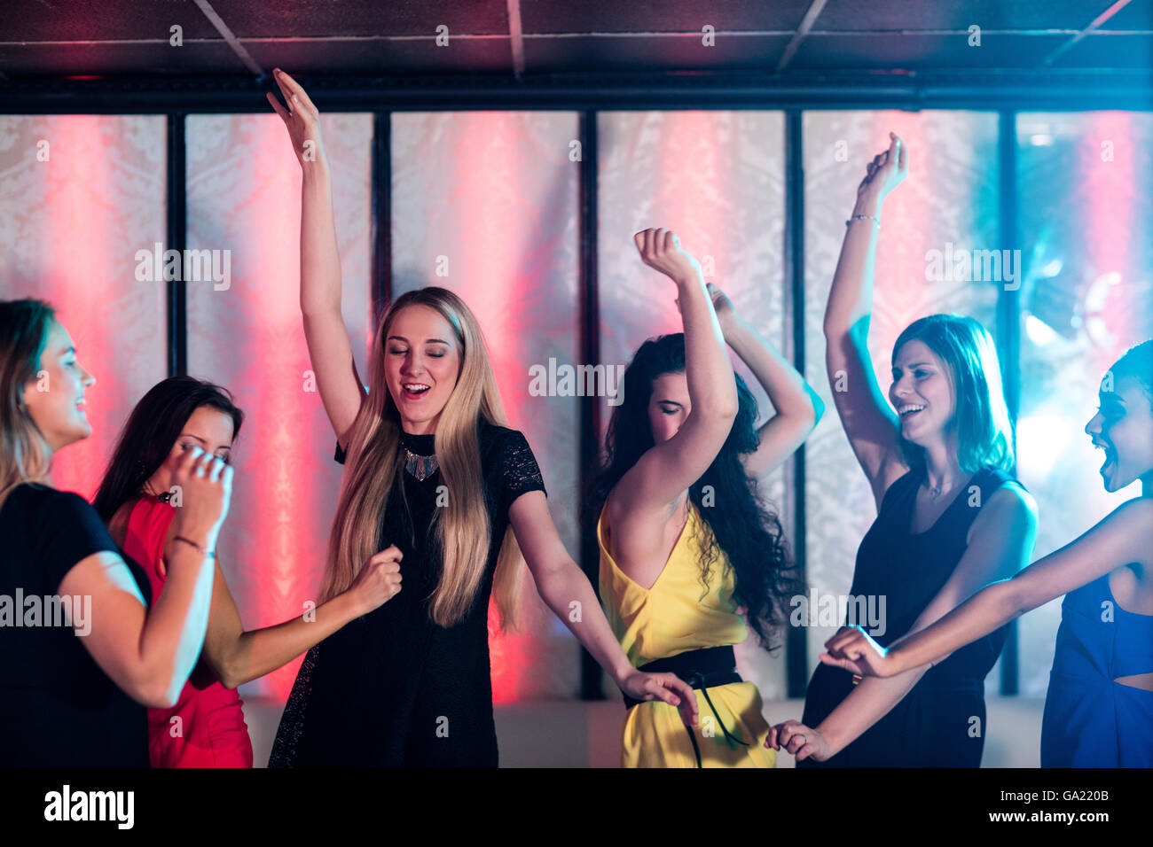 Smiling friends dancing on dance floor Stock Photo - Alamy