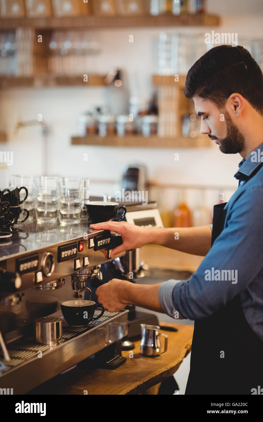 Man taking coffee from espresso machine Stock Photo - Alamy