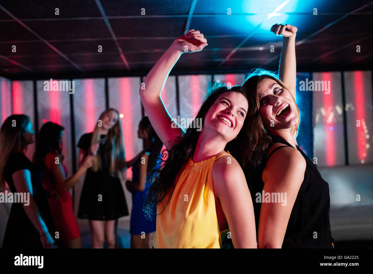 Smiling friends dancing on dance floor Stock Photo - Alamy