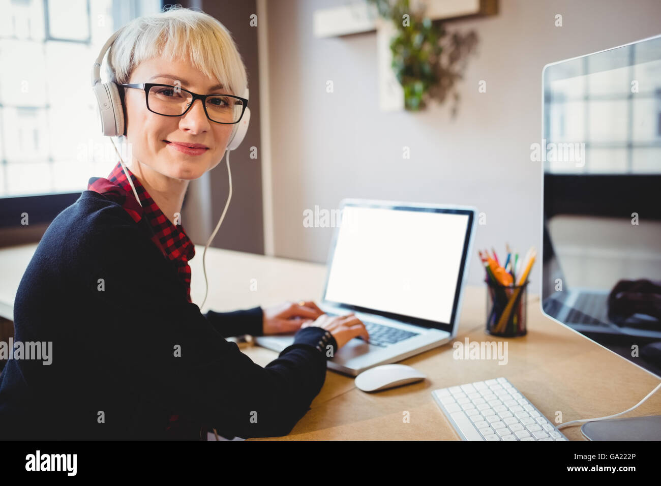 Female graphic designer working on laptop Stock Photo - Alamy