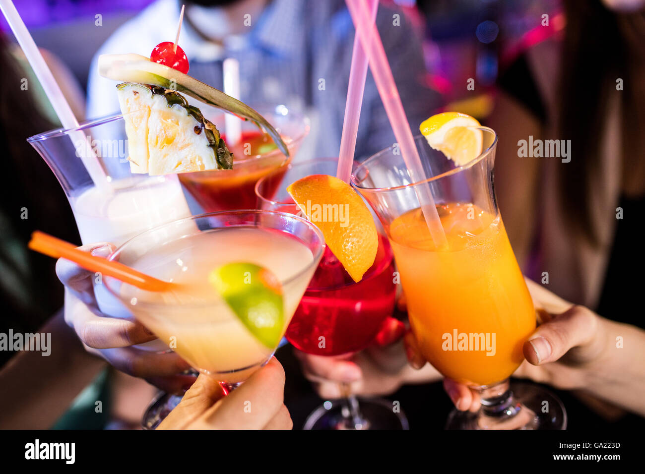 Group of friends toasting cocktail at bar counter Stock Photo - Alamy