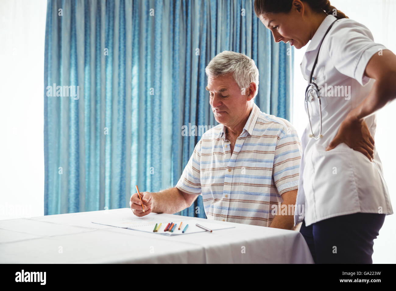 Senior man using a colouring book Stock Photo - Alamy