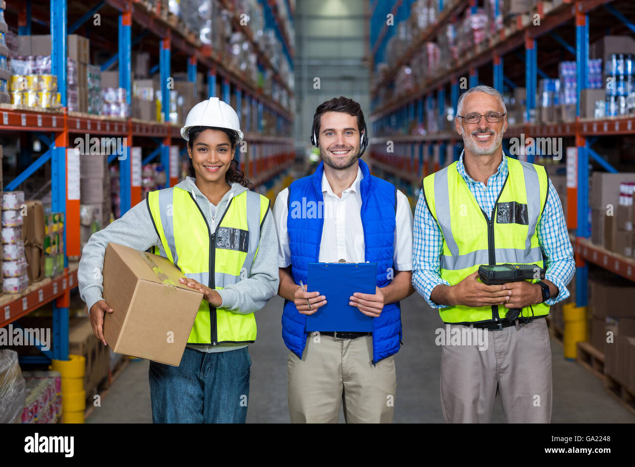 Warehouse workers looking at camera in warehouse Stock Photo - Alamy