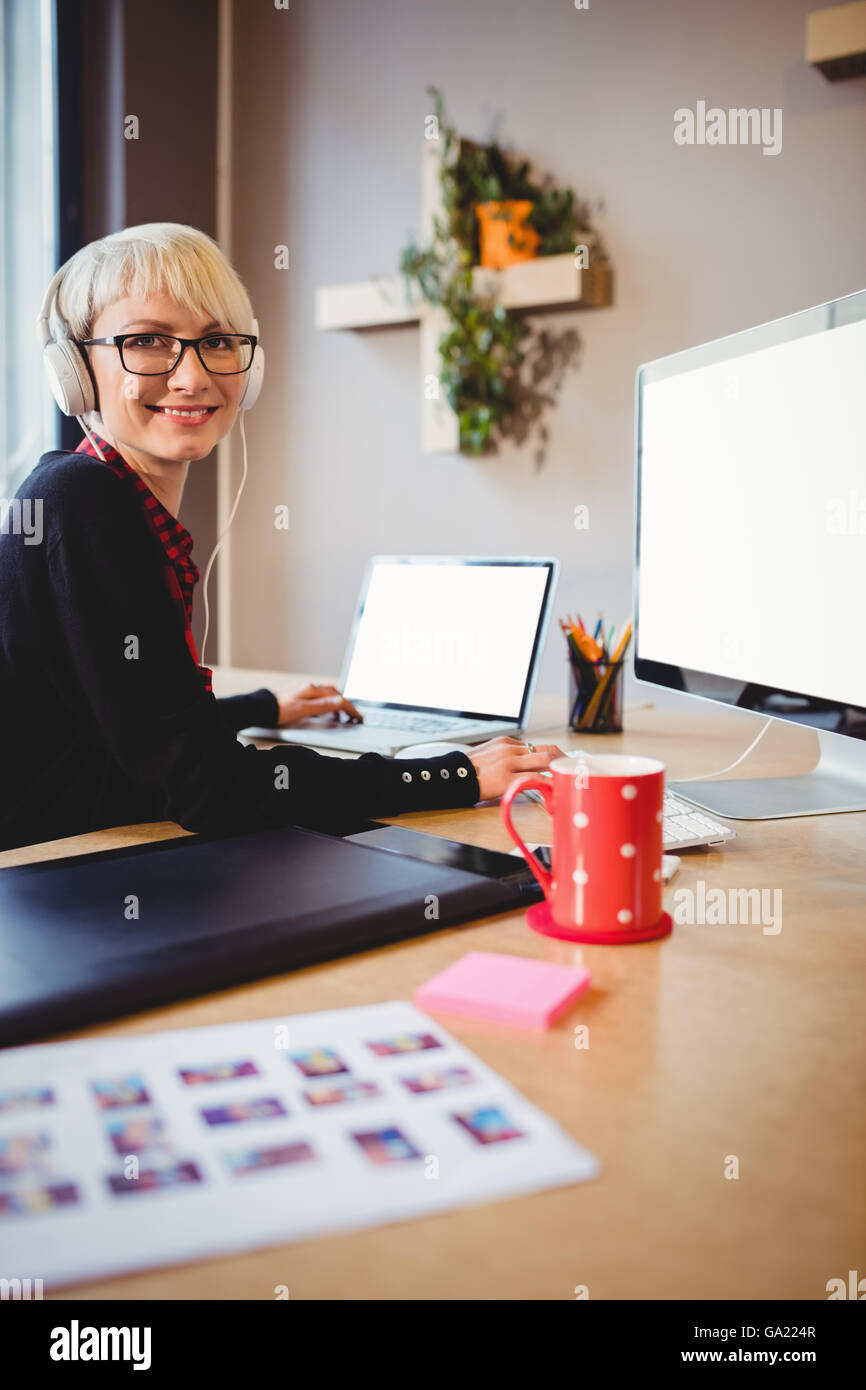 Female graphic designer working on computer and laptop Stock Photo - Alamy